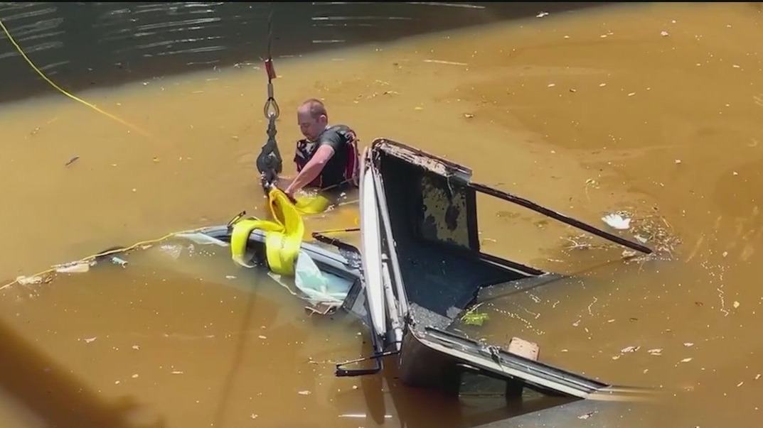 Firefighter dives into water to try save driver from submerged truck ...